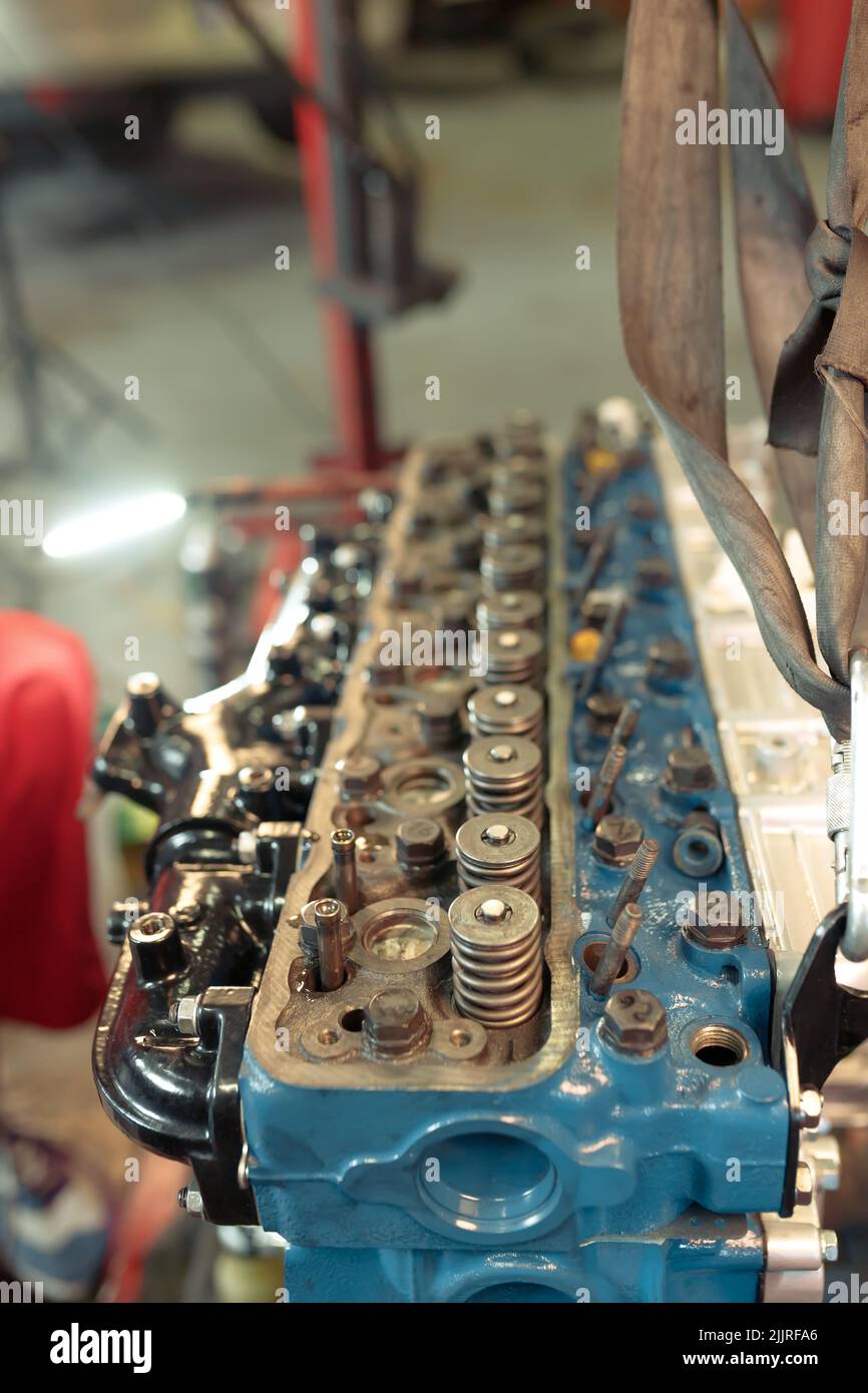 A vertical closeup shot of a mechanic mounting the car engine Stock ...