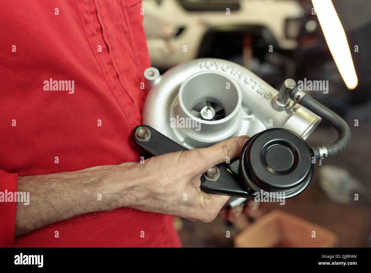 A closeup of a mechanic repairing the parts of a car engine Stock Photo ...