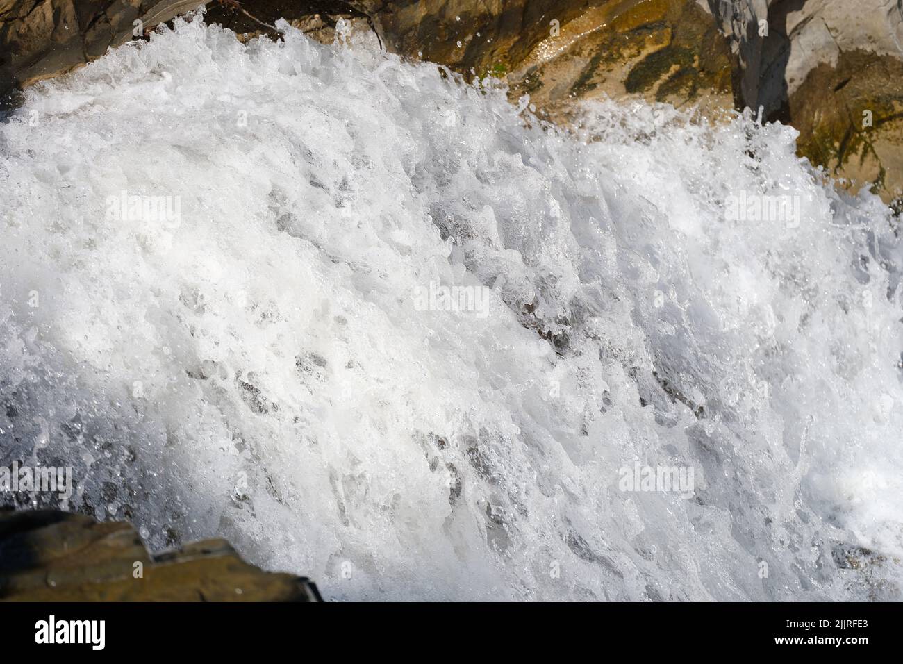 Bubbling river waterfall stream with white foam flows over stones Stock ...