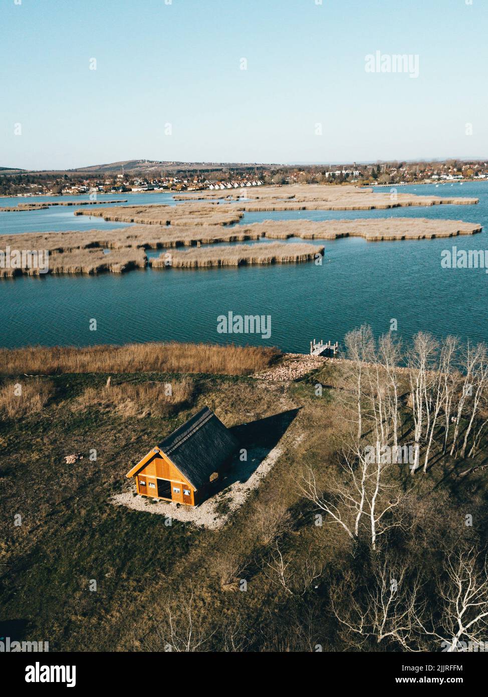 An aerial view of a small hut on a lakeshore in vertical Stock Photo ...