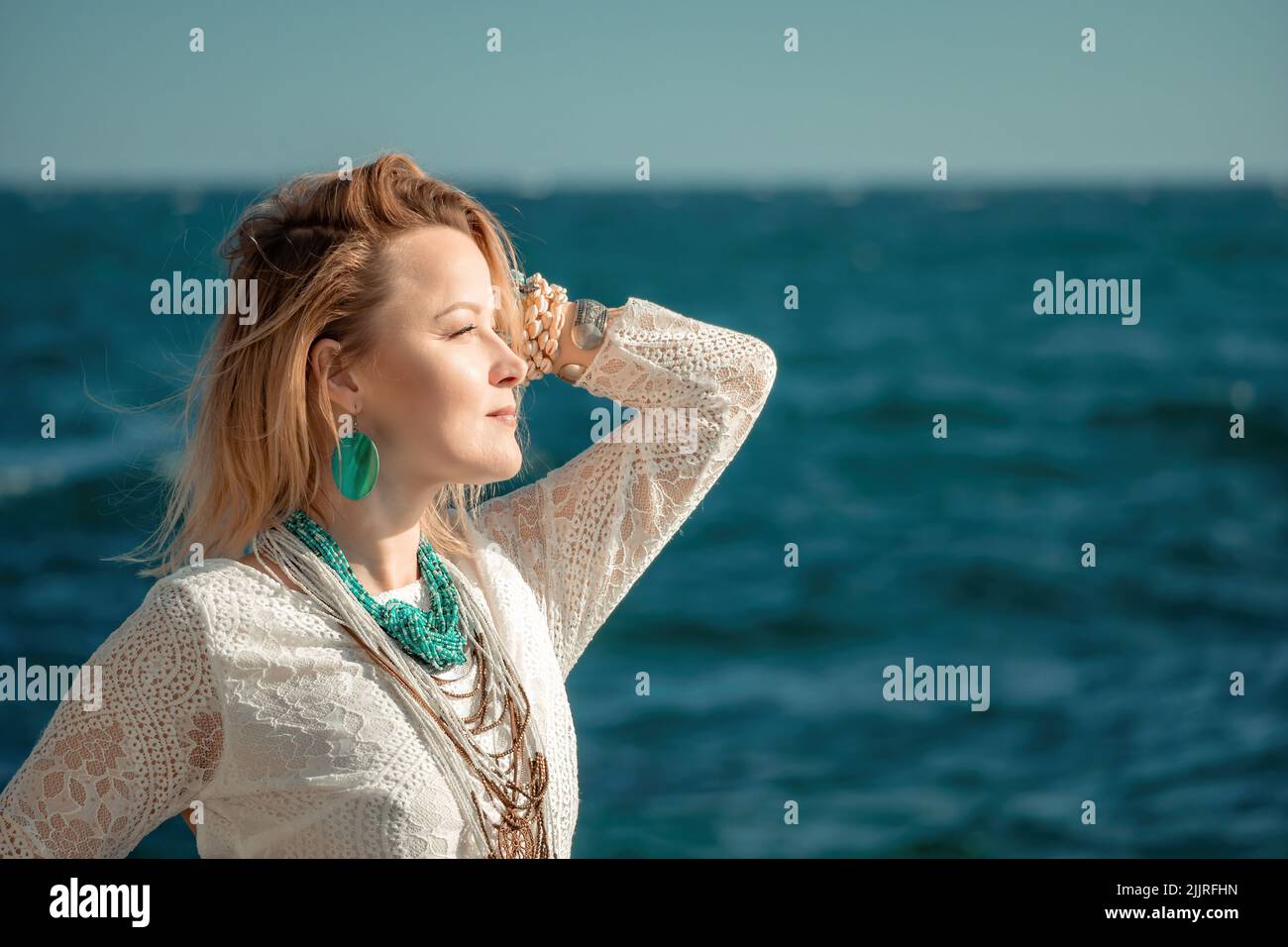 Woman in bohemian clothing on beach at sunset. Boho style for ...