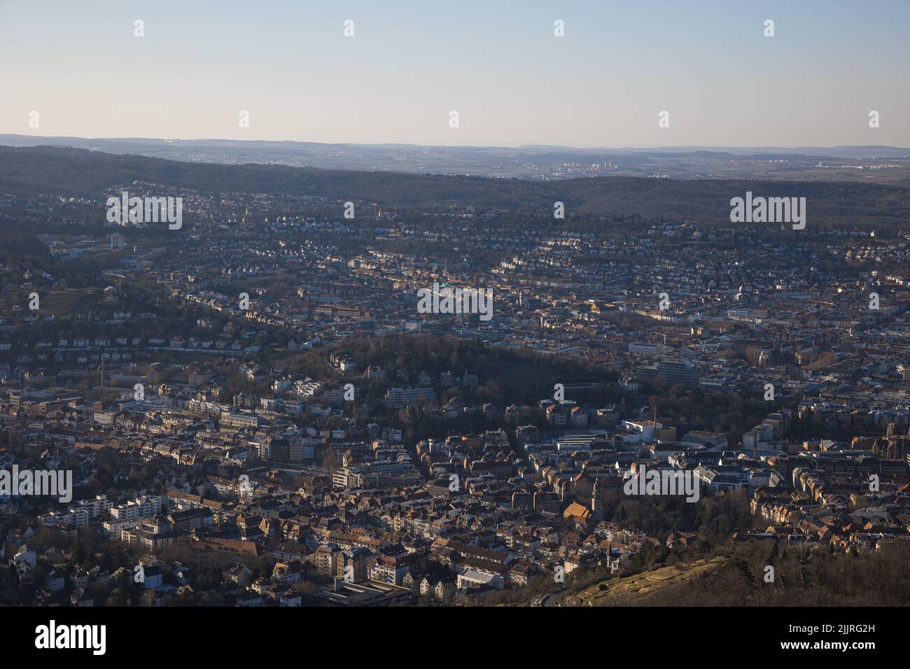 A scenic cityscape of Stuttgart with dense buildings and trees under ...