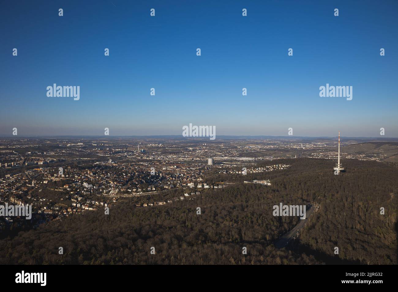 A scenic cityscape of Stuttgart with dense buildings and trees under ...
