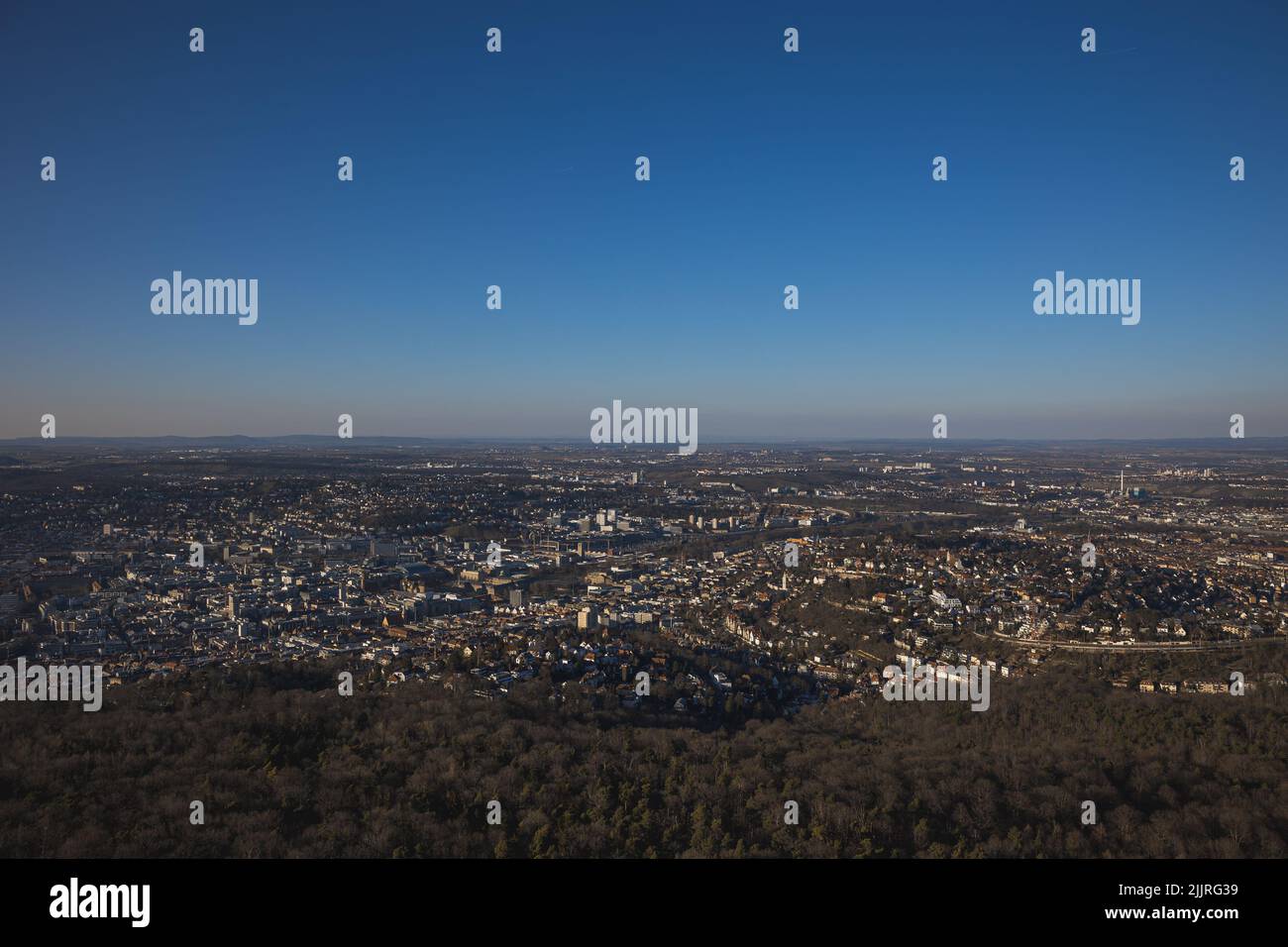 A scenic cityscape of Stuttgart with dense buildings and trees under ...
