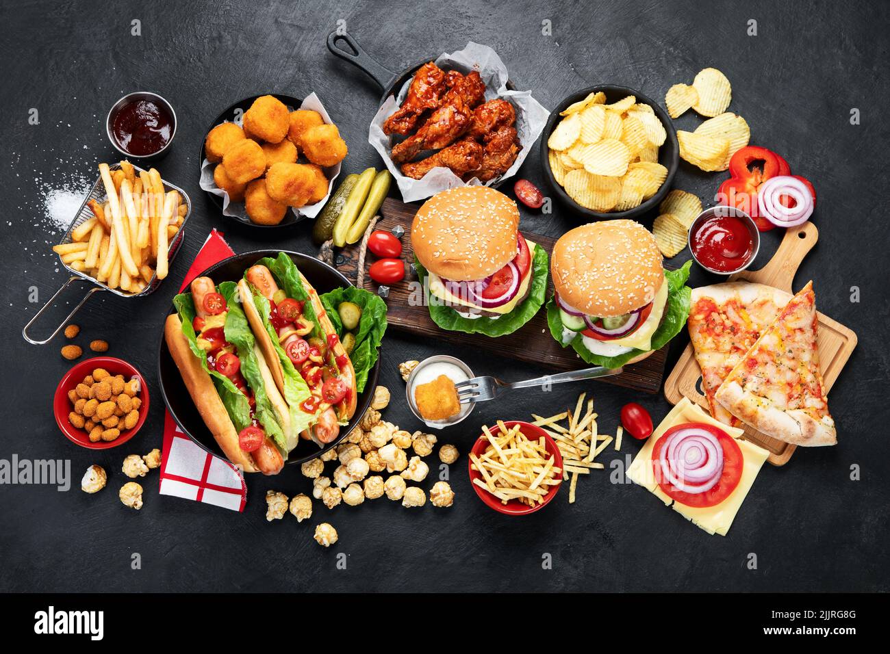 Fast food and unhealthy eating concept - close up of fast food snacks ...