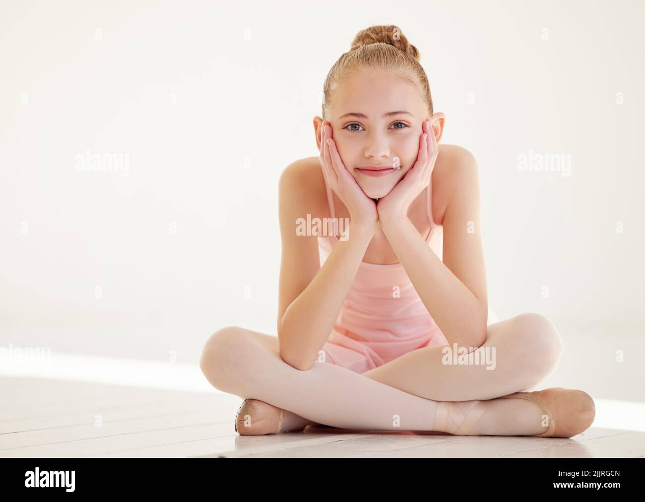 Ballet is the body rising. young ballerina sitting in a dance studio ...