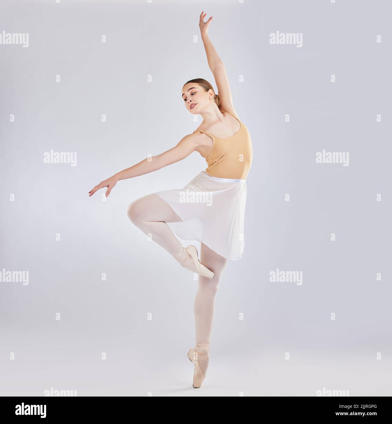 Feel with your feet. Studio shot of a young woman performing a ballet ...