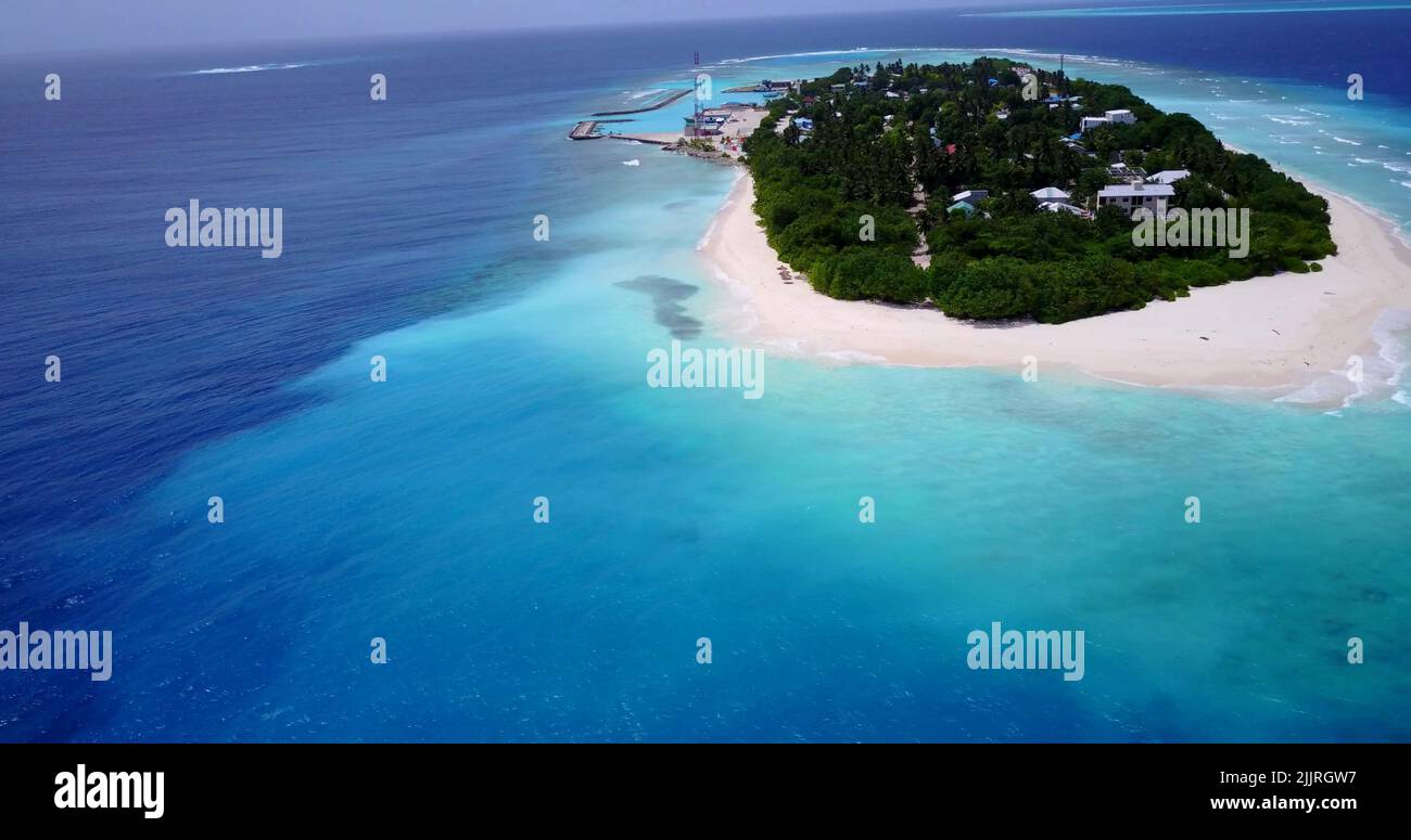 An aerial view of a small island with houses and trees surrounded by ...