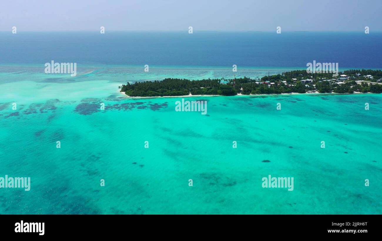 An aerial view of an island with houses and trees surrounded by the ...