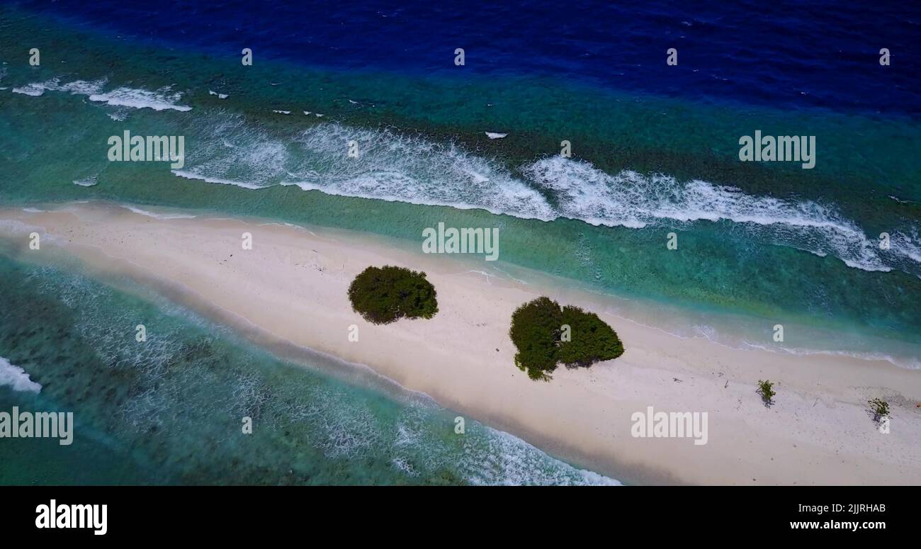 An aerial drone shot of a small sandy beach of an island in the ...