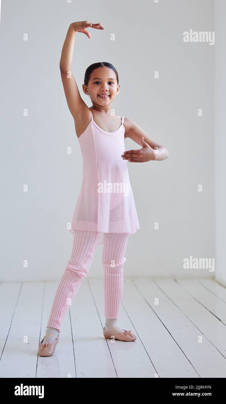 Theres magic in dance. Portrait of a little girl practicing ballet in a ...