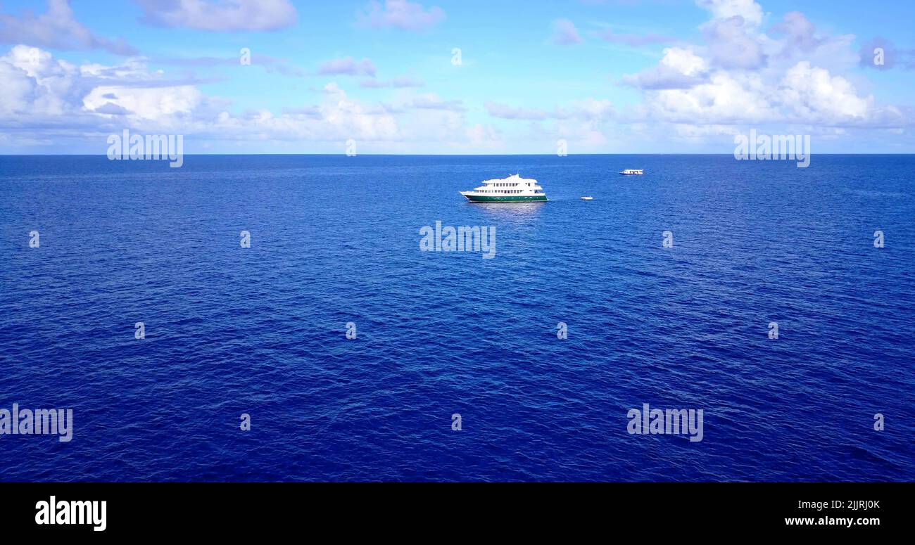 An aerial view of boats in the open sea under a cloudy sky Stock Photo ...