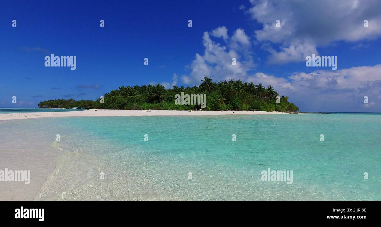 The lush green tropical beach on The Maldives from the sea Stock Photo ...