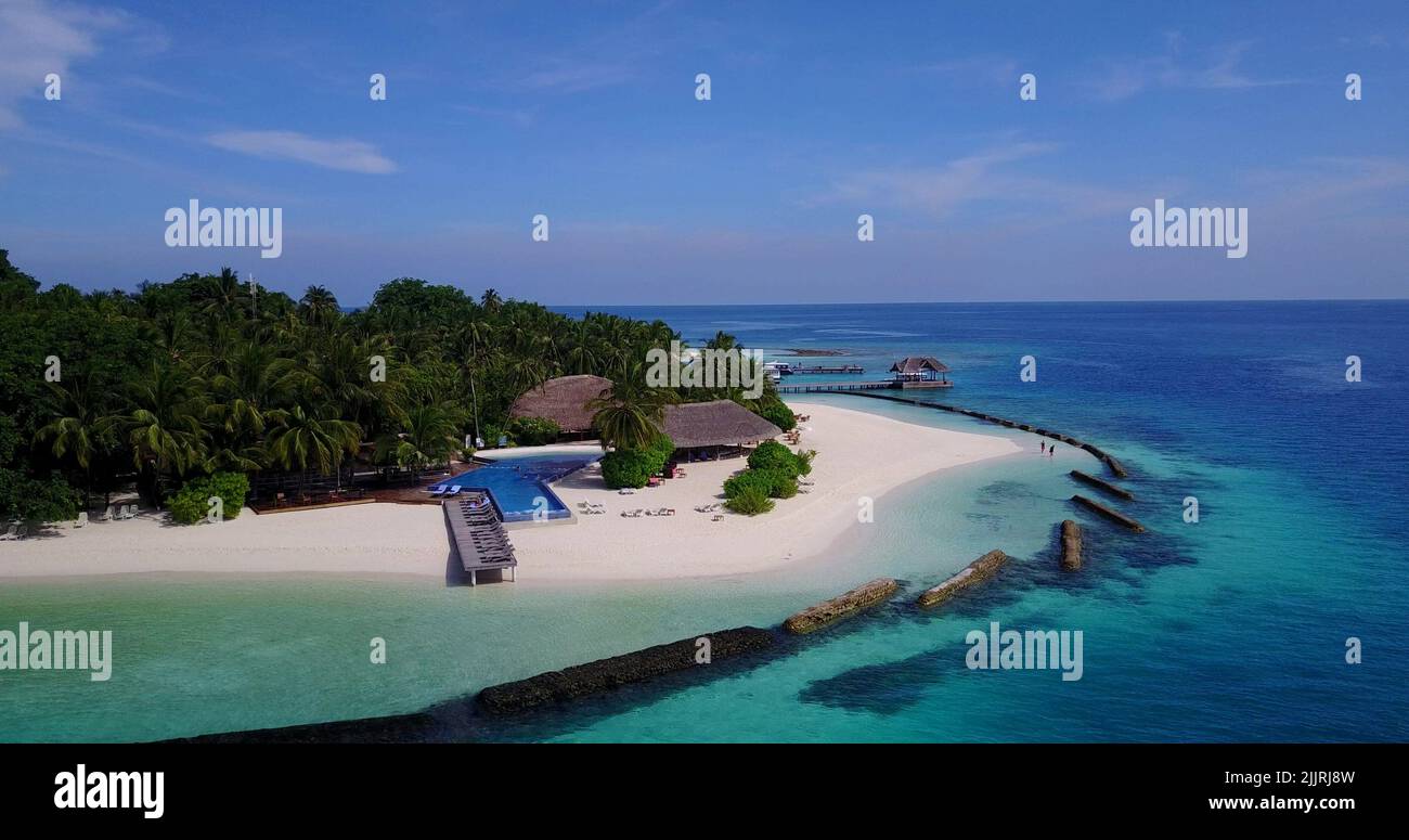 The green tropical beach in The Maldives from the sea on blue cloudy ...
