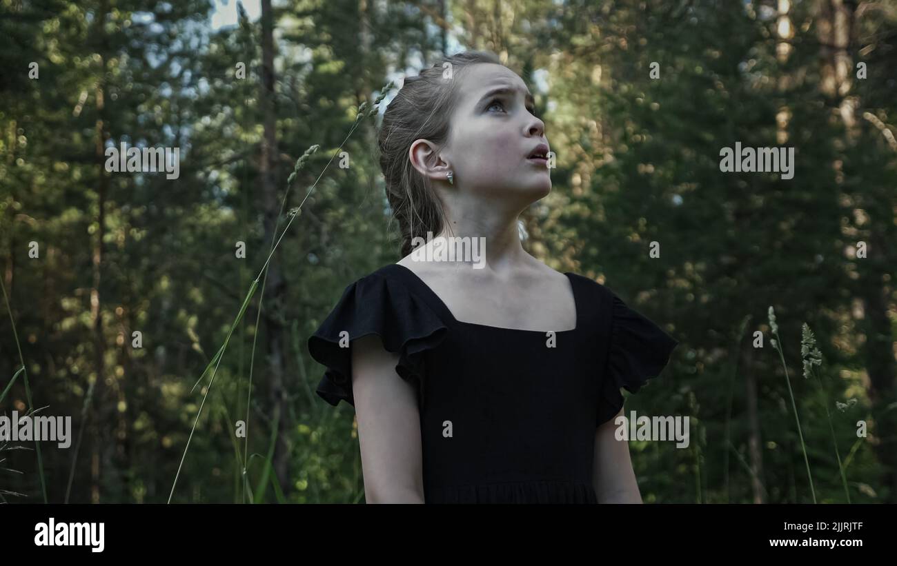 Schoolgirl lost in dark forest and screams crying closeup Stock Photo ...