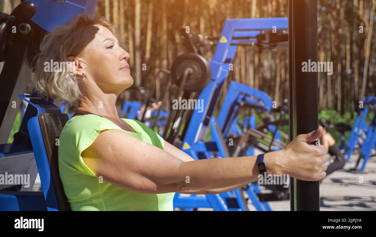 Middle-aged lady does strength training for upper body Stock Photo - Alamy