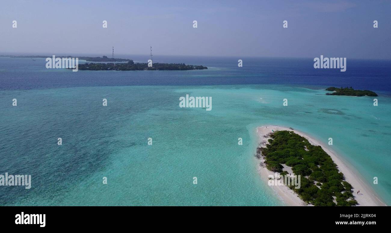 An aerial view of small islands with trees in the middle of the ocean ...