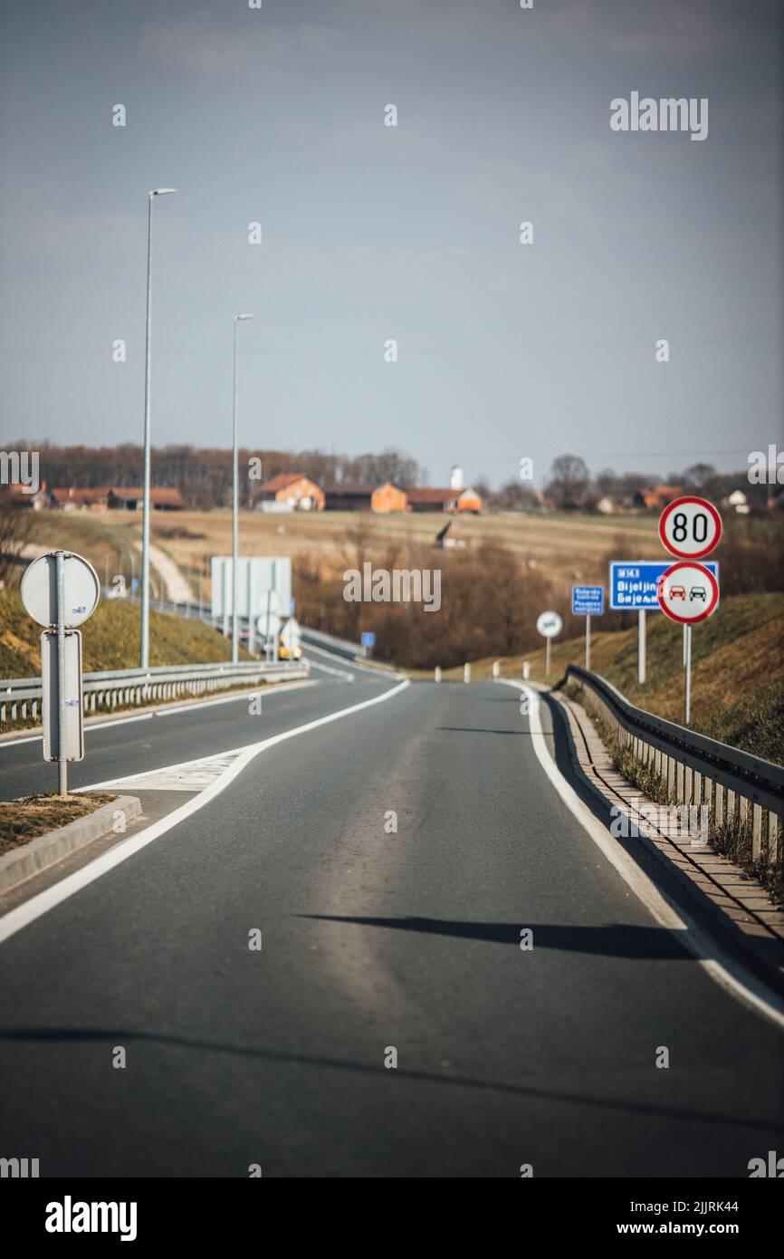 A vertical shot of traffic signs on the road in Brcko, Bosnia and ...