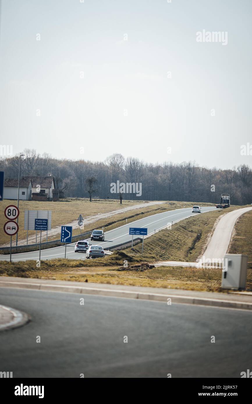 A vertical shot of traffic signs on the road in Brcko, Bosnia and ...