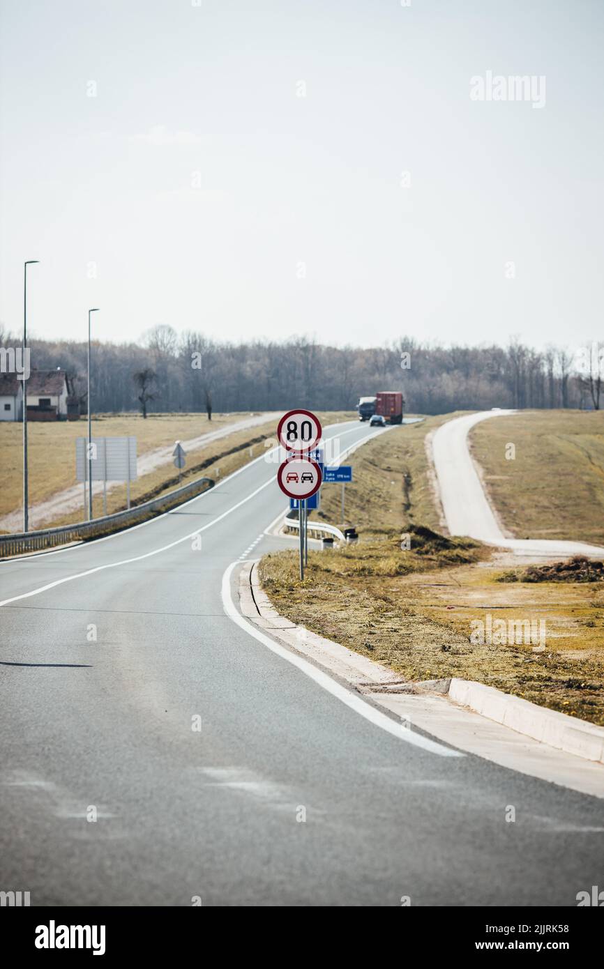A vertical shot of traffic signs on the road in Brcko, Bosnia and ...