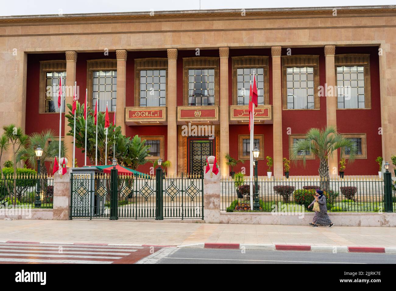 Two women walking alongside the Moroccan parliament Stock Photo - Alamy