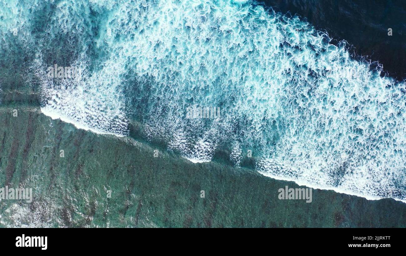 A beautiful view of a sea with foamy waves in Asia Stock Photo - Alamy