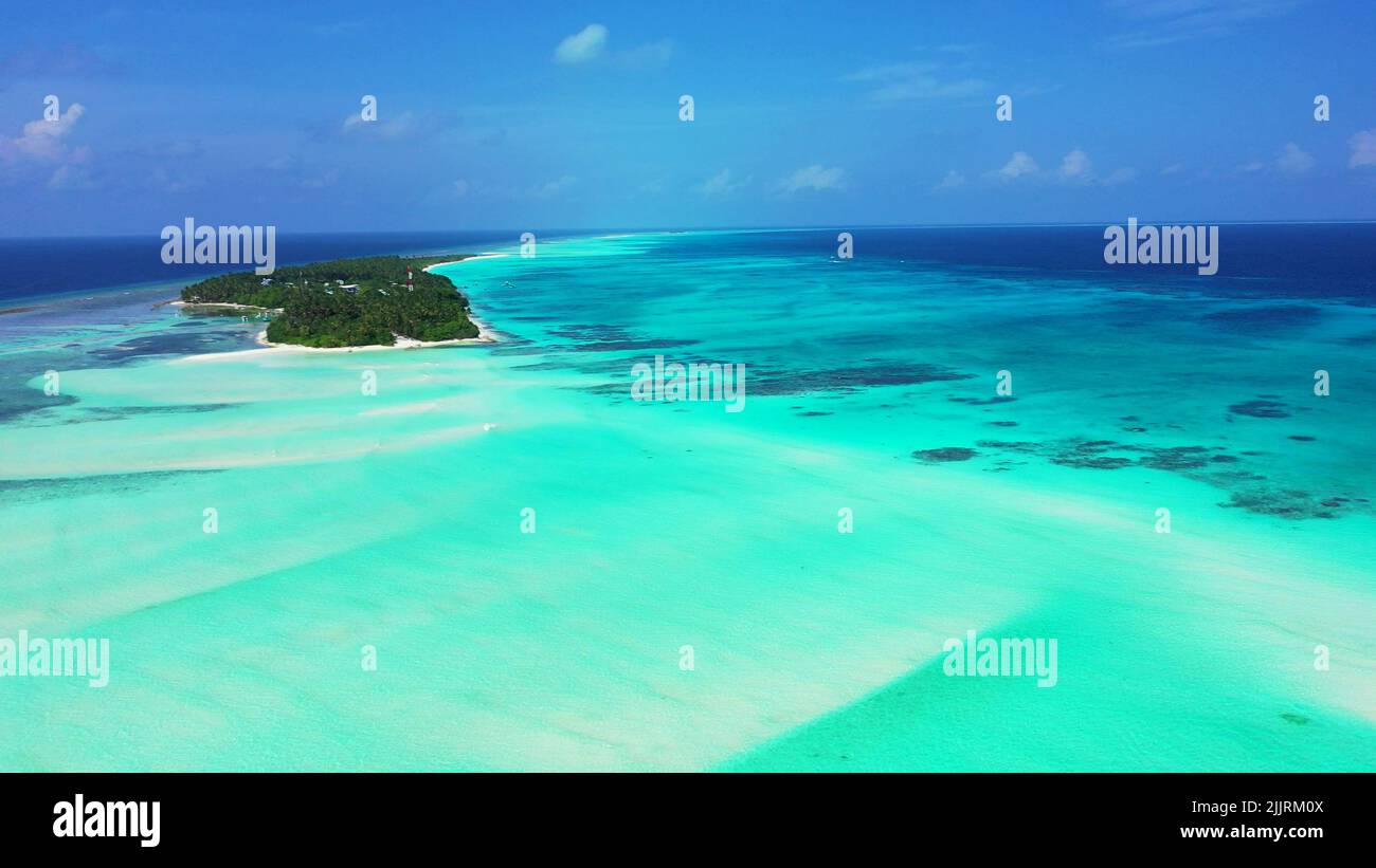 An aerial view of a small tropical island with a white sandy beach and ...