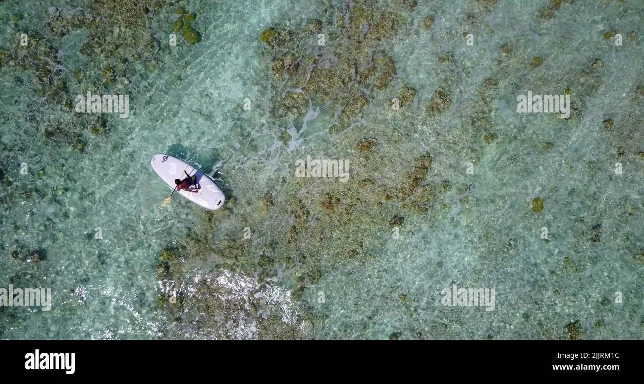 An aerial shot above sandy beach by a boat in the tranquil water Stock ...