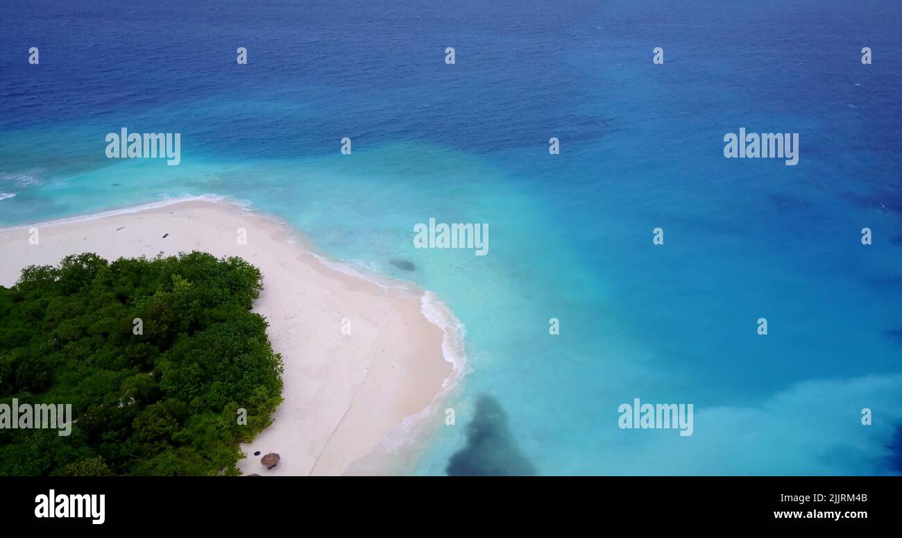An Aerial view of a small tropical island with a white sandy beach and ...