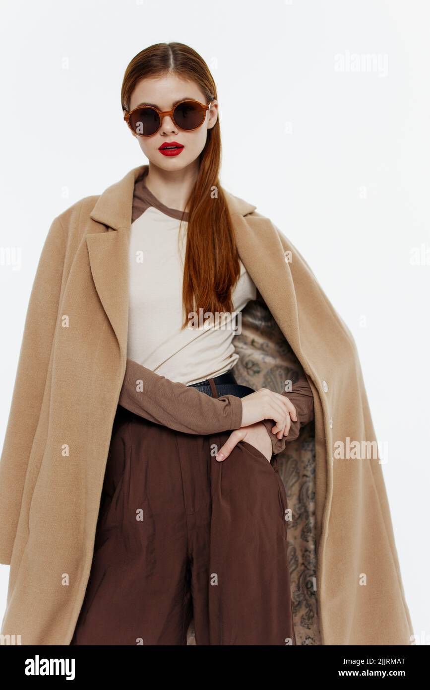 Hey, look at me concept. A spectacular elegant female model in a coat ...