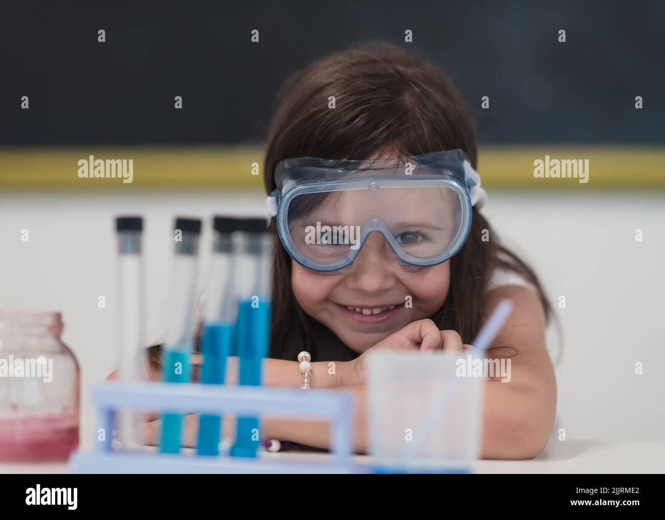 Elementary School Science Classroom: Little girl Mixes Chemicals in ...