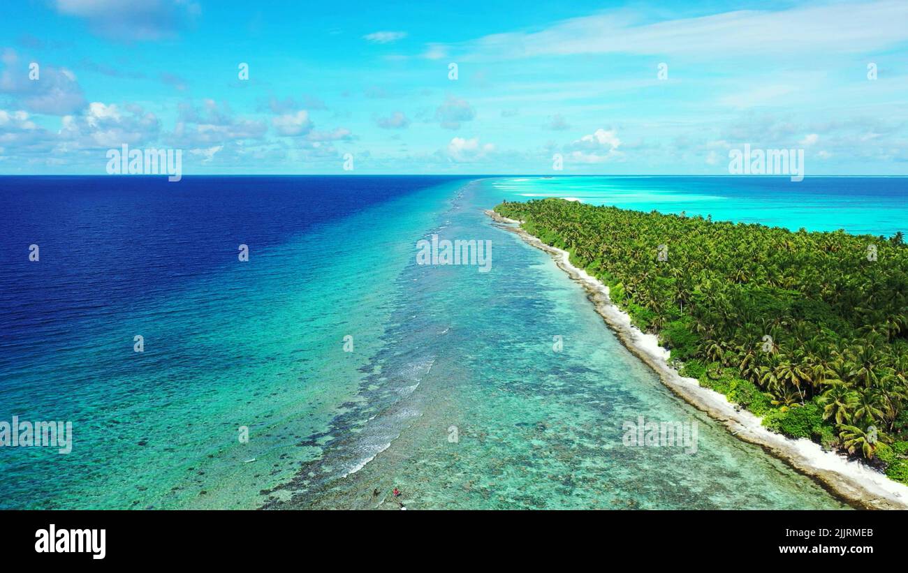 An aerial shot of a tropical island in the azure ocean Stock Photo - Alamy