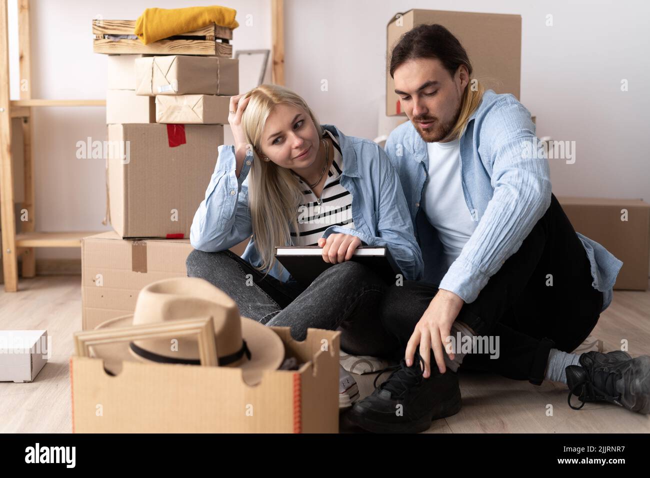 Couple moving in house, happy couple relaxing while sitting near ...