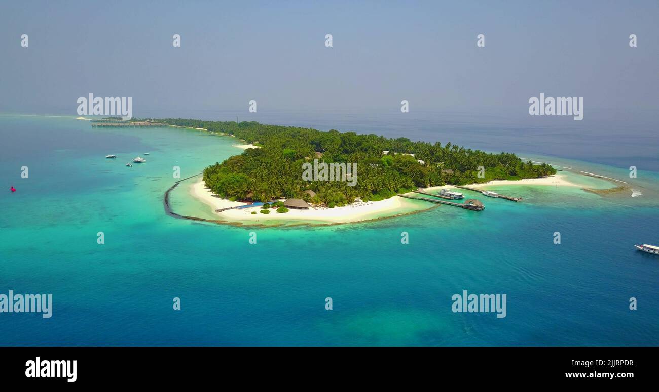 A drone shot of a small green island with turquoise water in The ...