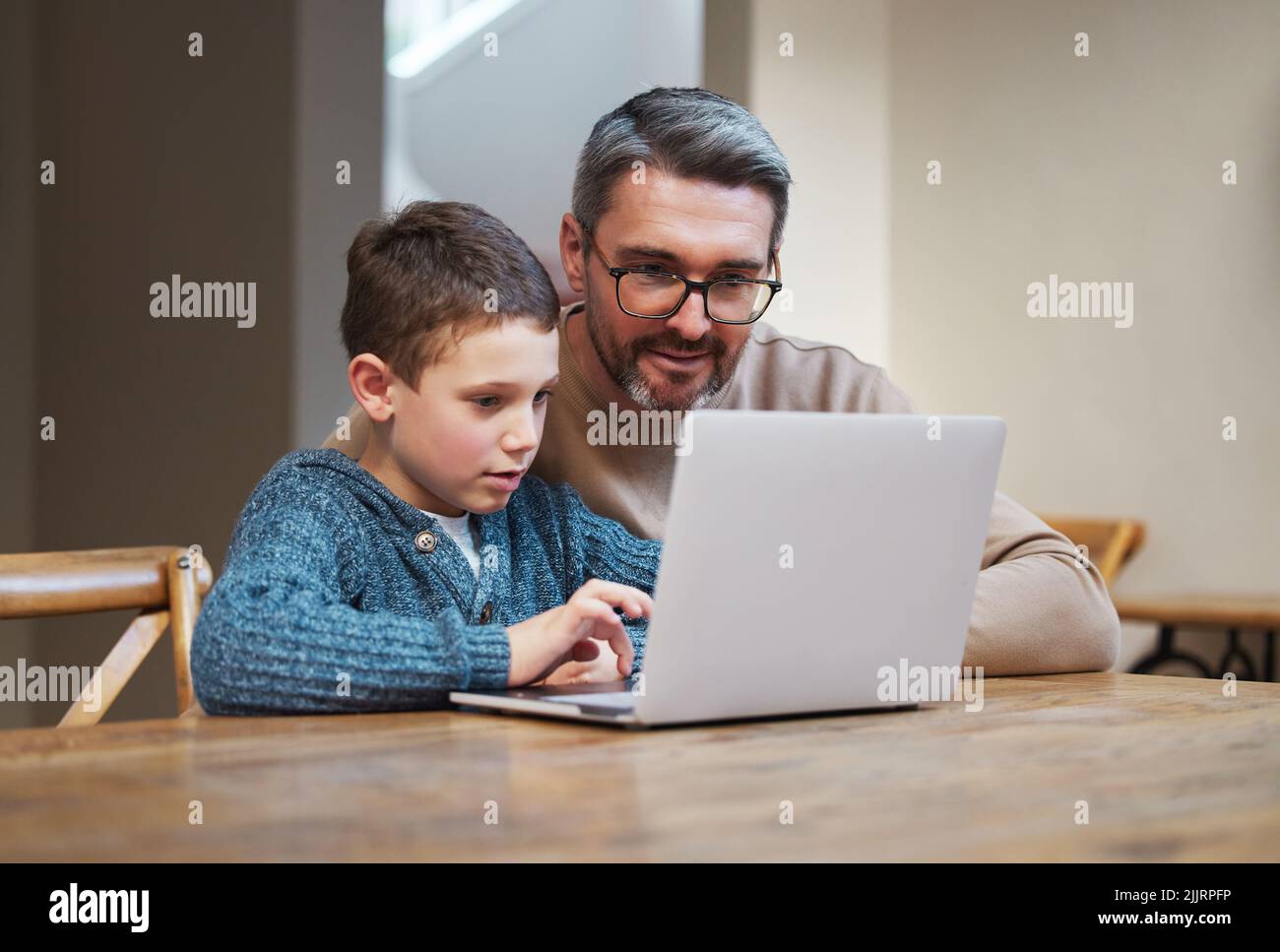 Focus and itll make sense. a father and son team using a laptop to ...