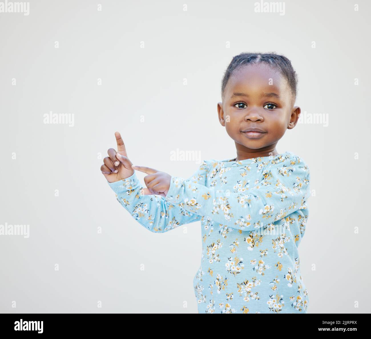 Think Im cute Check this out. an adorable little girl standing against ...