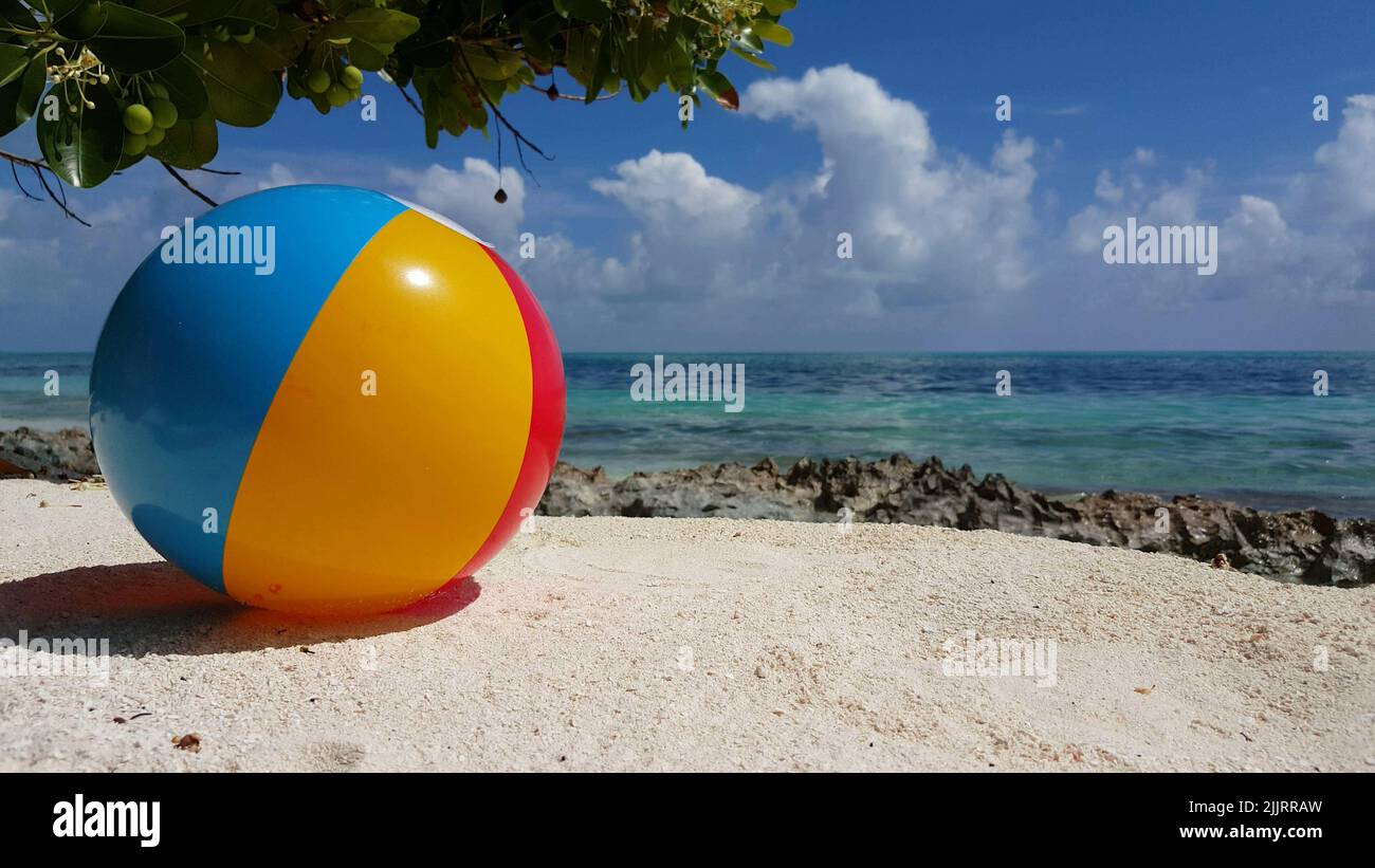 A colorful ball on a sandy beach in a background of a seascape Stock ...