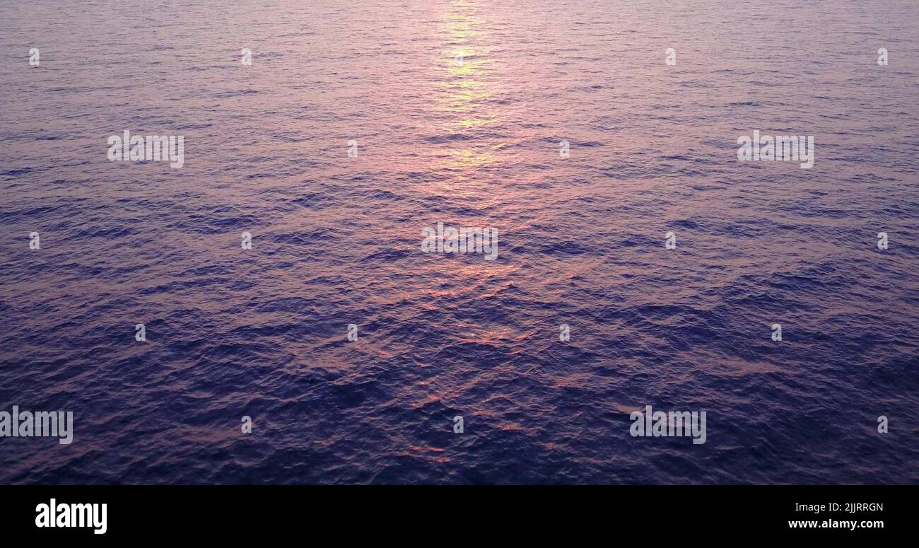 The rays of the setting sun over the ocean water in the Maldives Stock ...