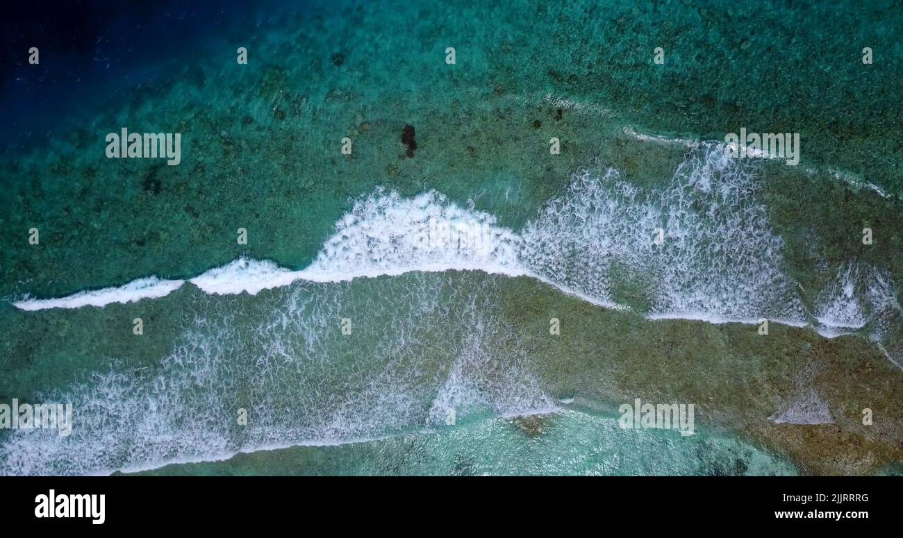 An aerial drone view of a beautiful tropical island with clear water ...