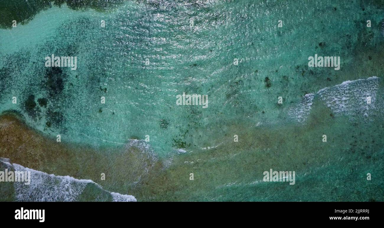 An aerial drone view of a beautiful tropical island with clear water ...