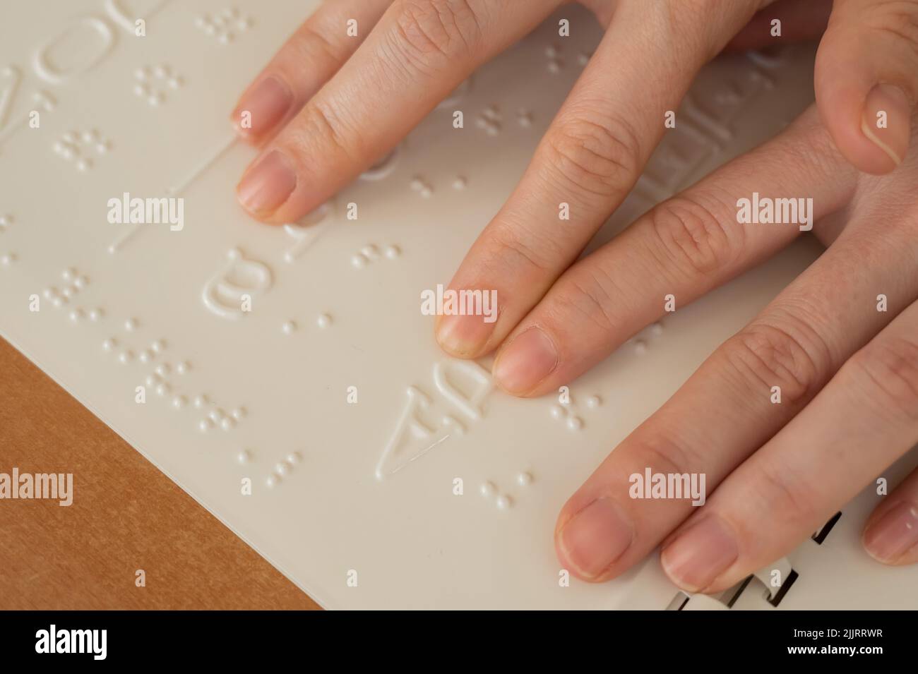 A woman learns the Braille alphabet using a decoder Stock Photo - Alamy