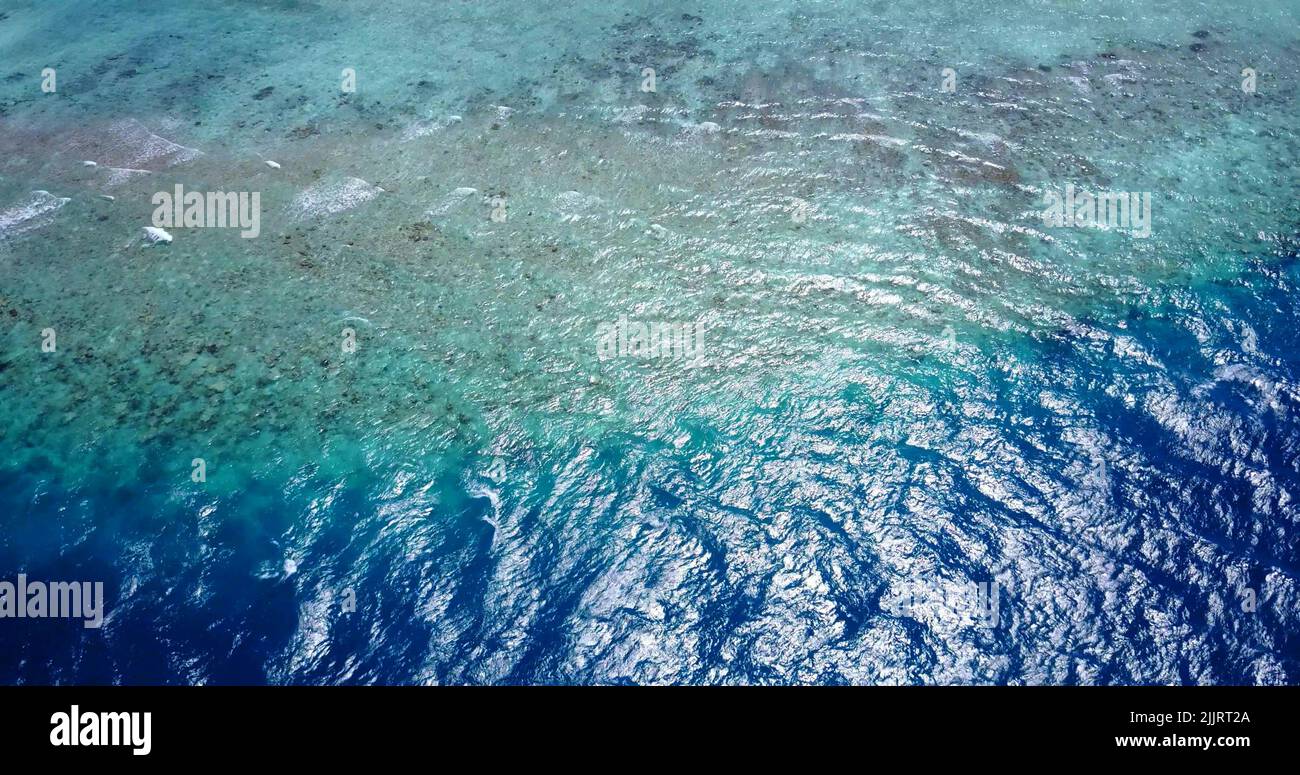 A beautiful view of turquoise and deep blue water ripples mixing in an ...