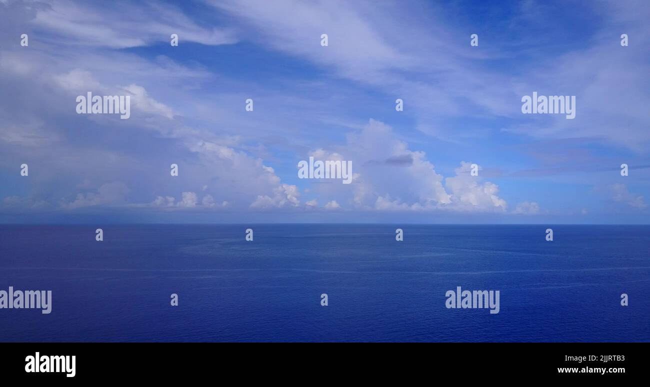 The blue ocean water merging with the cloudy sky over the Maldives ...