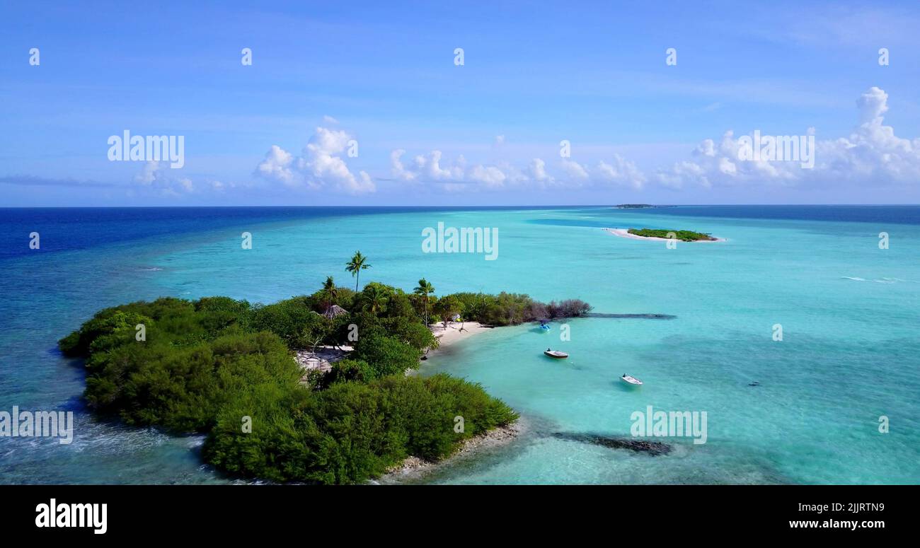 An aerial view of a beautiful tropical island with crystal clear blue ...