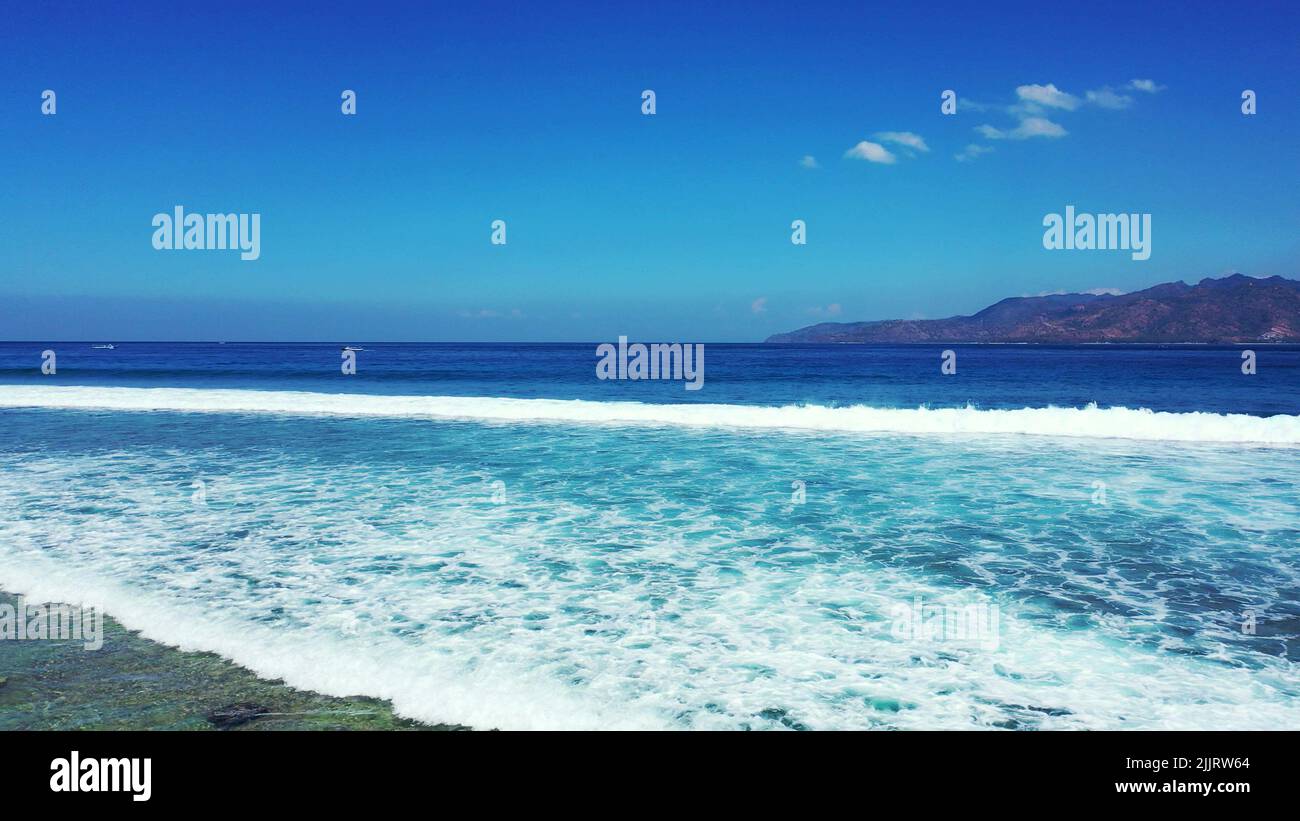 A beautiful view of a sea with foamy waves on a summer sunny day Stock ...