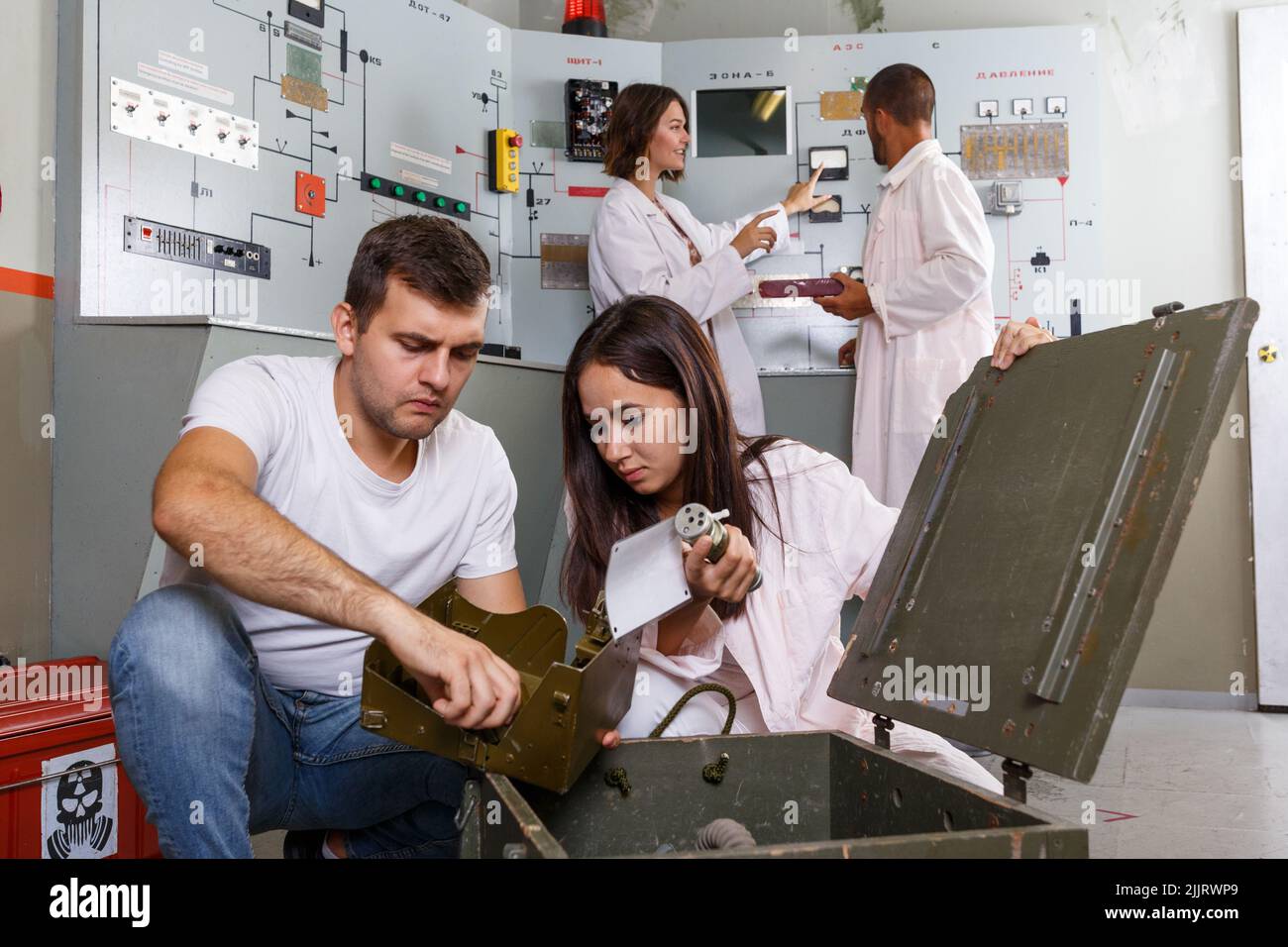 Friends inspecting box with facilities in quest room Stock Photo - Alamy