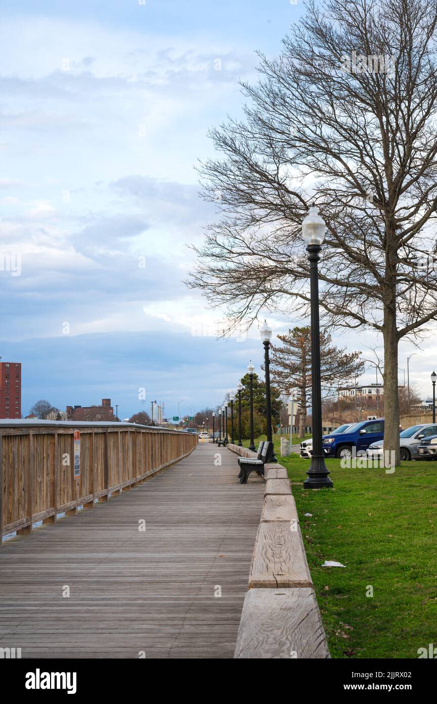 A vertical shot of a boardwalk along the Battleship Cove museum in Fall ...