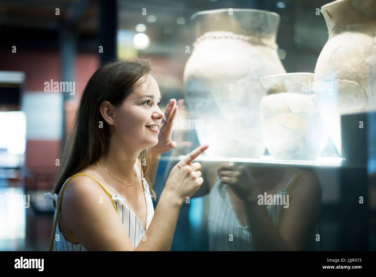 beautiful girl considers exhibits in museum Stock Photo - Alamy