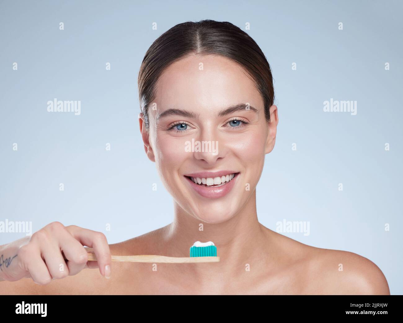 I brush my teeth twice daily. Studio portrait of an attractive young ...