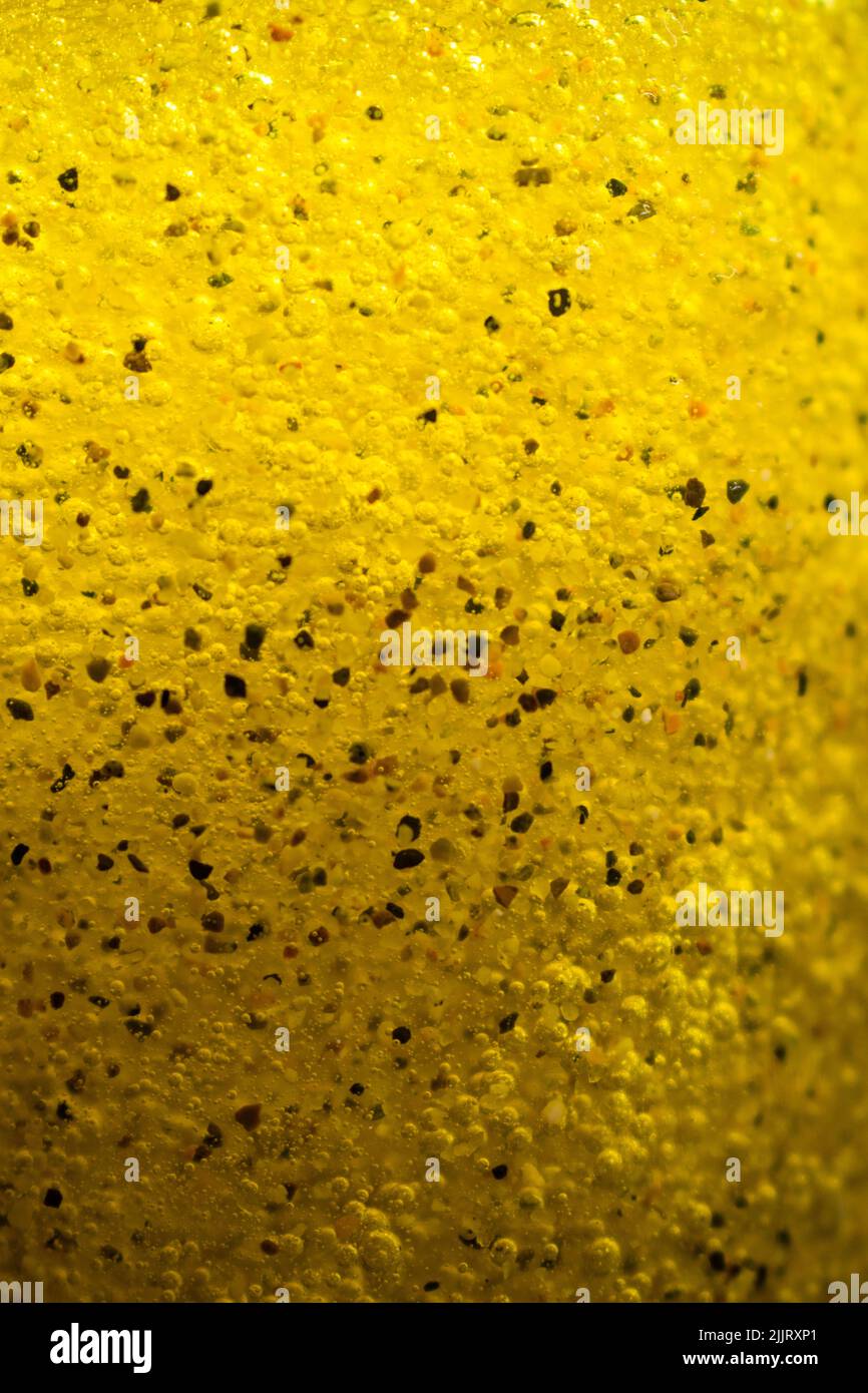 A vertical shot of yellow substance background with bubbles Stock Photo ...
